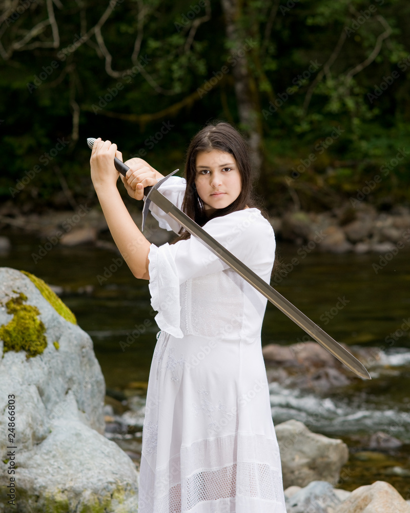 Young girl in white dress with two handed sword Stock Photo | Adobe Stock