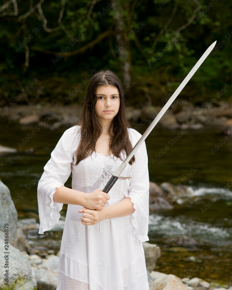 Young girl in white dress with two handed sword Stock Photo | Adobe Stock