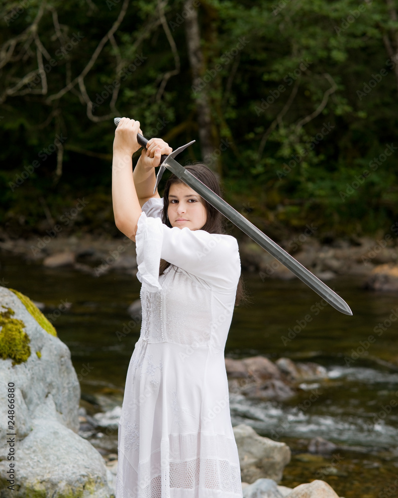 Young girl in white dress with two handed sword Stock Photo | Adobe Stock