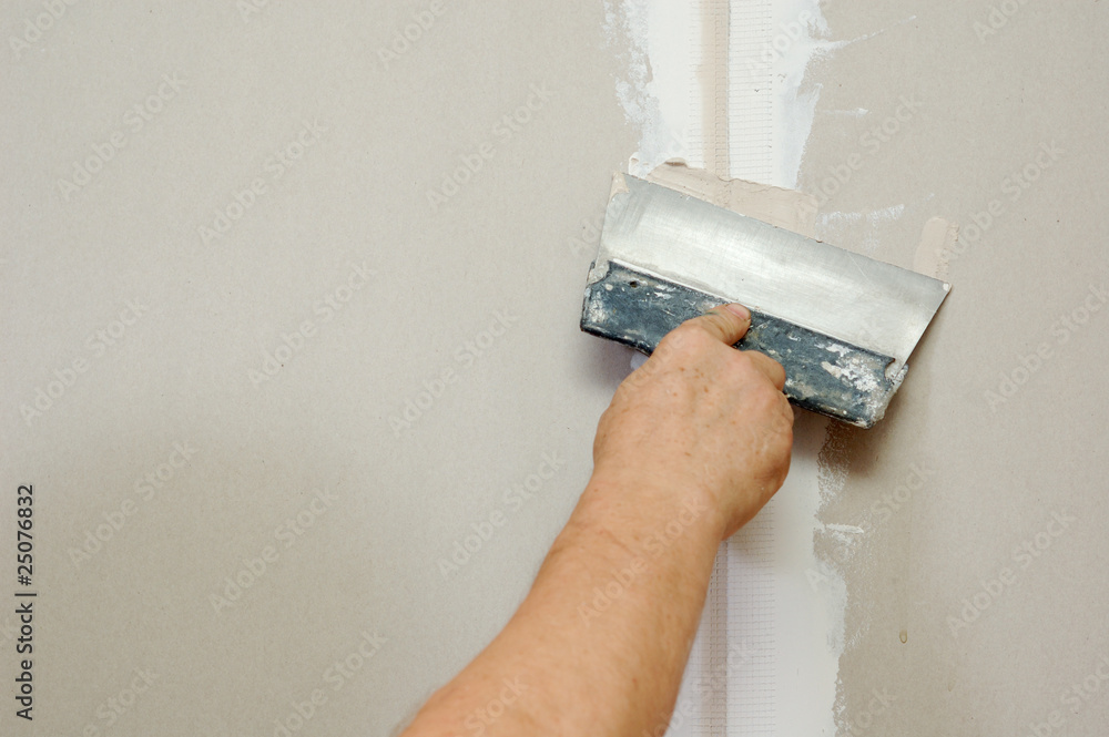man putty plasterboard Stock Photo | Adobe Stock