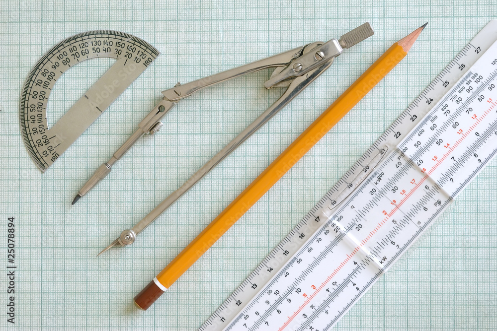 Compasses, pencil, protractor and slide rule Stock Photo | Adobe Stock