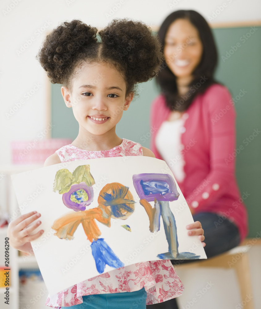Proud student holding painting in classroom Stock Photo | Adobe Stock