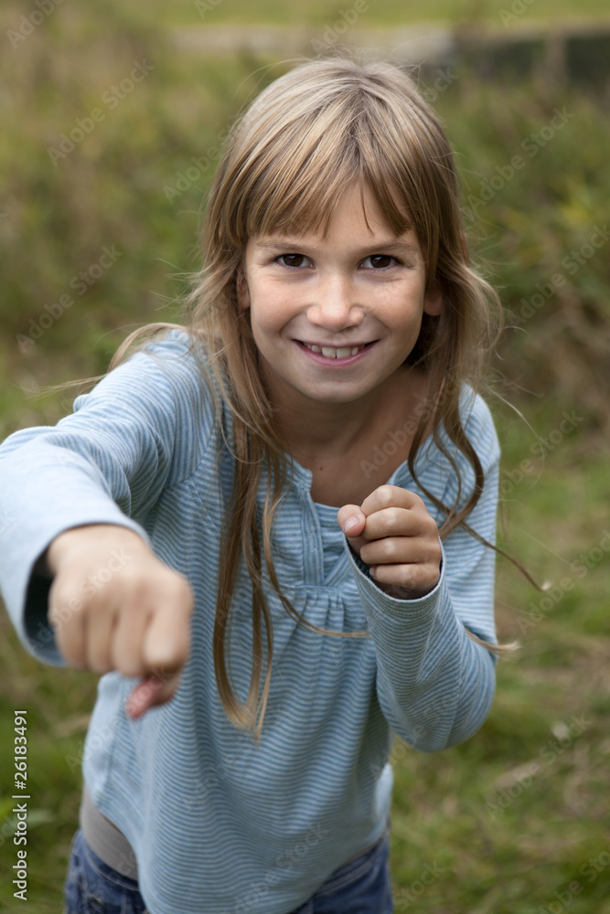 Fun angry aggressive little girl. foto de Stock | Adobe Stock