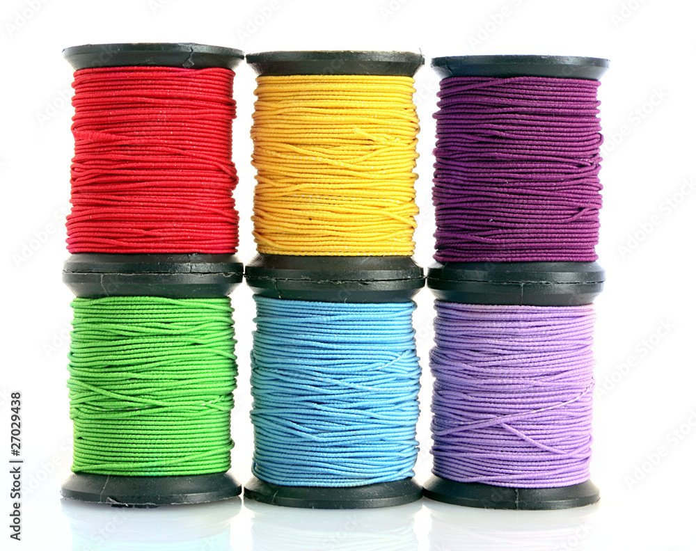 Coloured bobbins of thread isolated on white Stock Photo | Adobe Stock