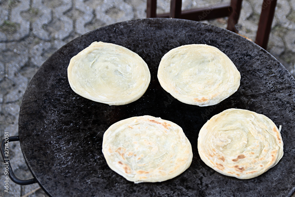 Roti on hot pan Stock Photo | Adobe Stock