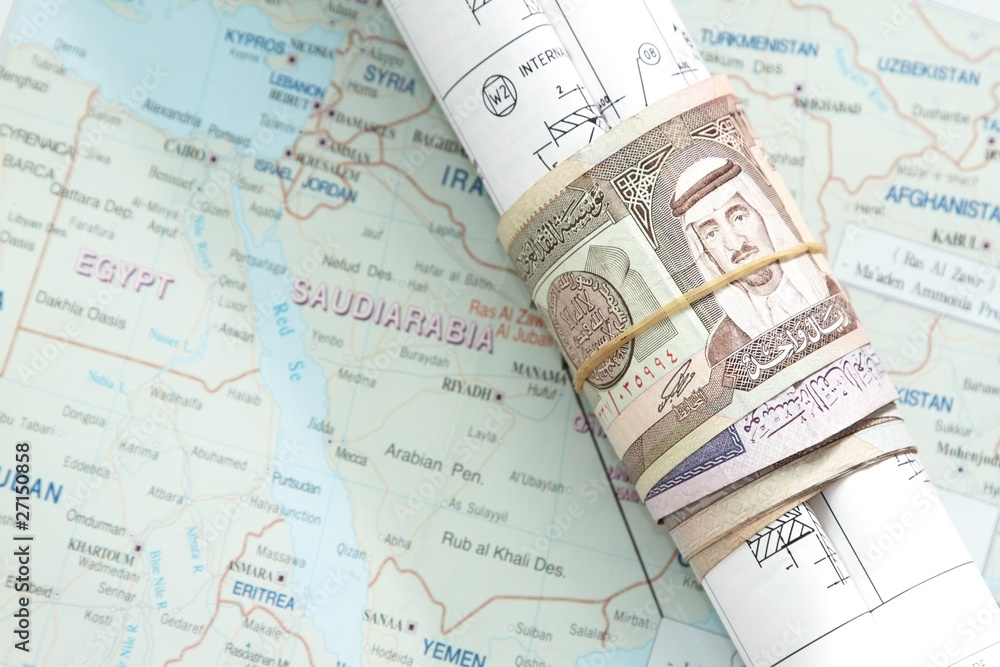 Rolled saudi arabian money in a blueprint Stock Photo | Adobe Stock