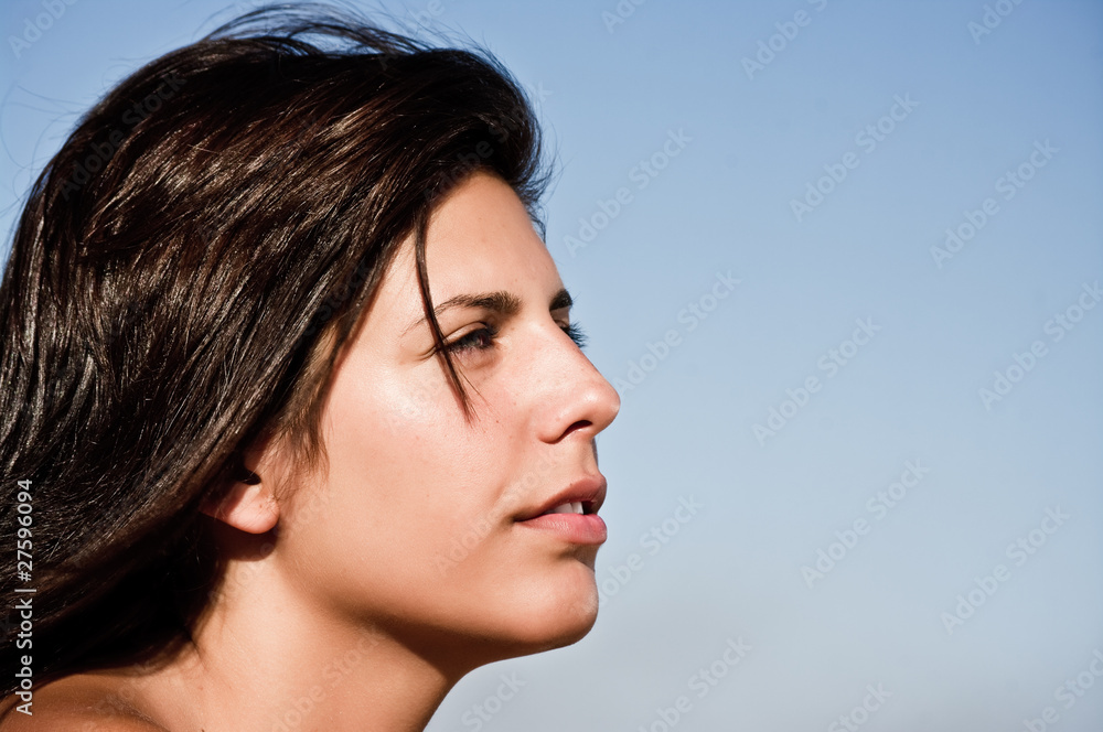 Profile of beautiful Spanish girl with blue background Stock Photo ...