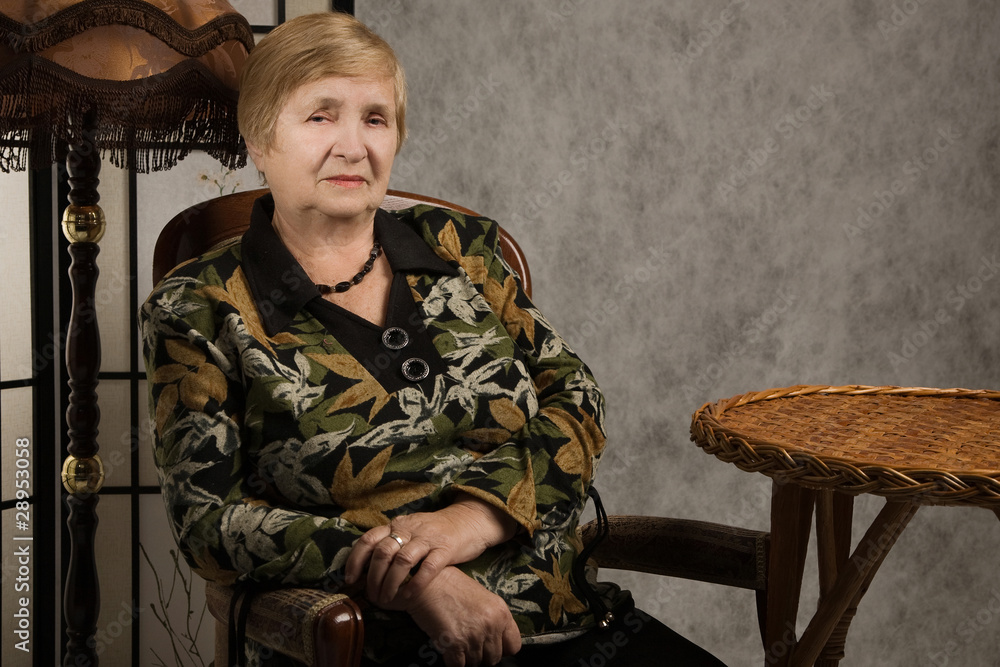 Old woman in a vintage style interior Stock Photo | Adobe Stock