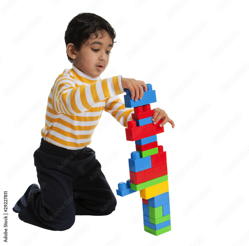 Toddler Making a tall Building with Blocks Stock Photo | Adobe Stock