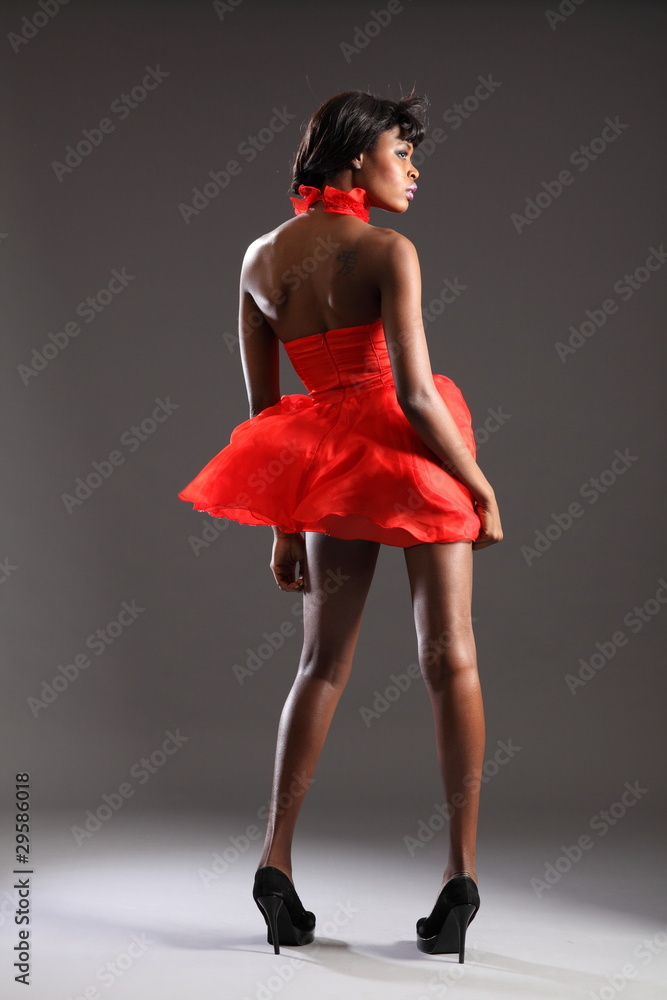 Sexy black fashion model in red dress and heels Stock Photo | Adobe Stock