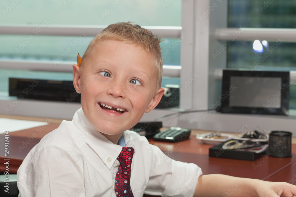 Funny young boy making a goofy face in a business office Stock Photo ...