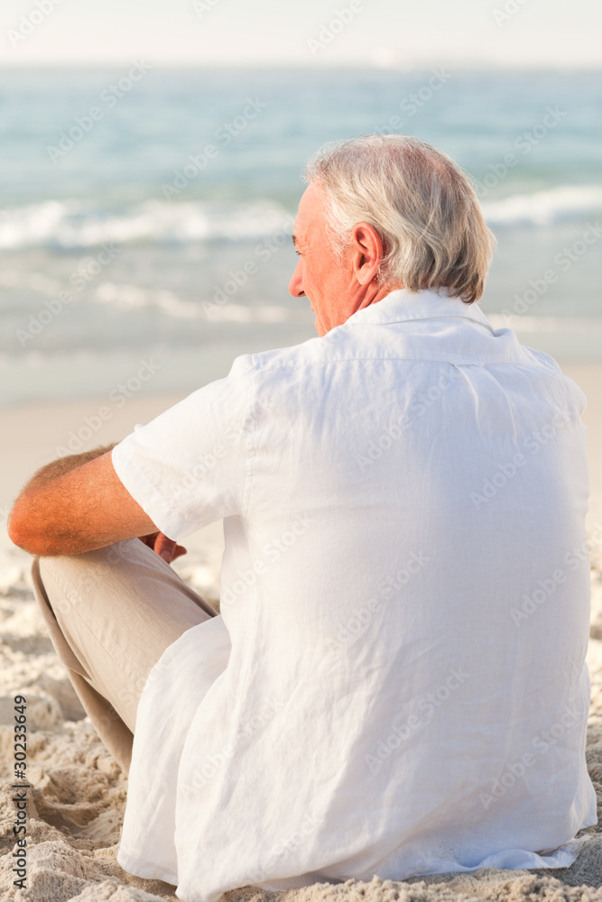 Man sitting on the beach Stock Photo | Adobe Stock