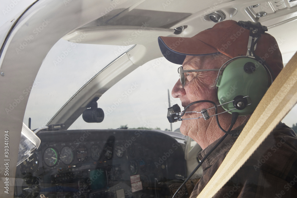 Senior Pilot in the cockpit of a Cessna twin engine Stock Photo | Adobe ...