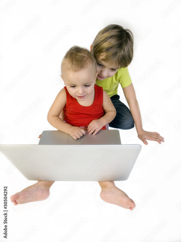Foto Stock two happy kids having fun with a laptop | Adobe Stock
