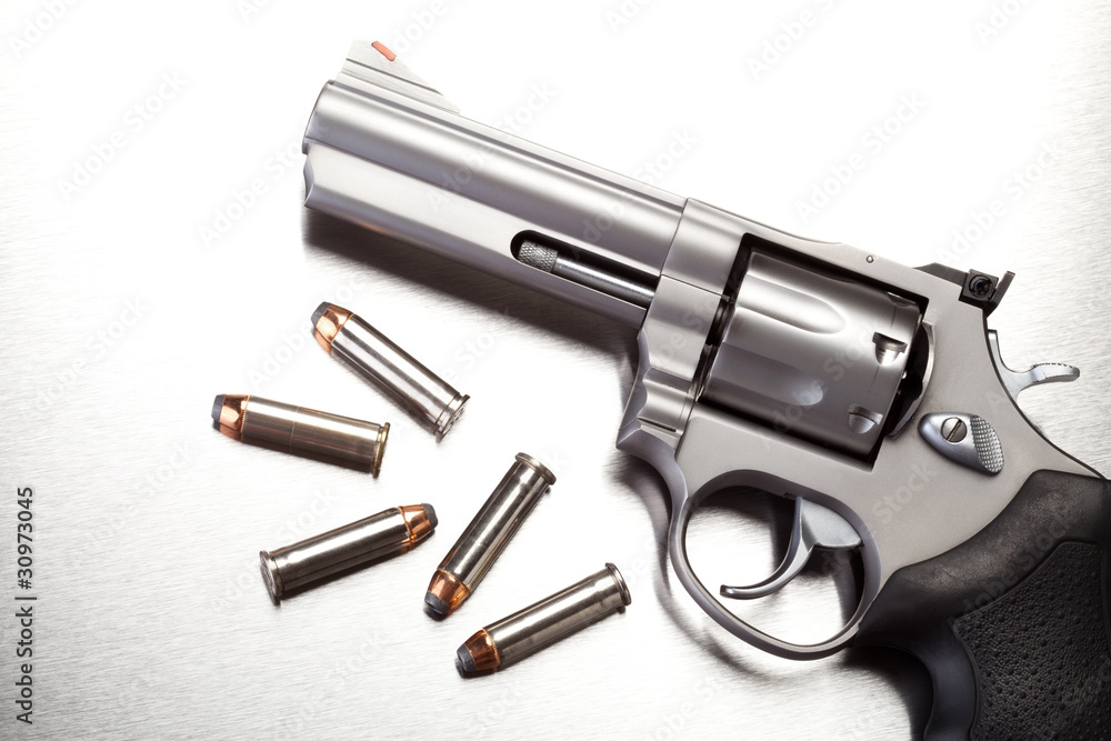 gun with bullets on steel - modern revolver handgun Stock Photo | Adobe ...