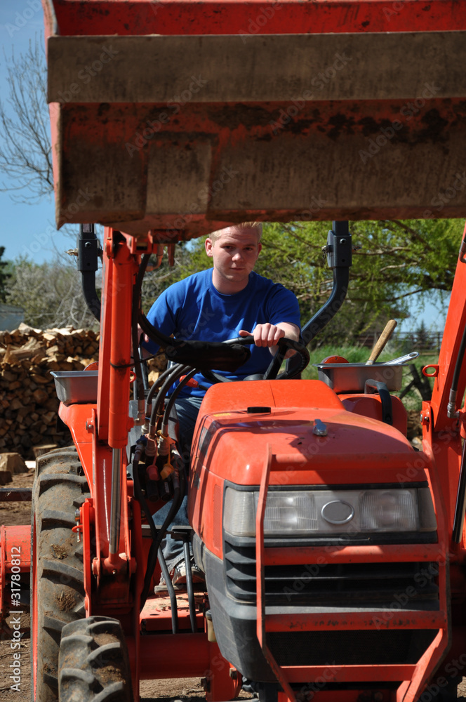 Teenage Boy on Tractor Stock Photo | Adobe Stock