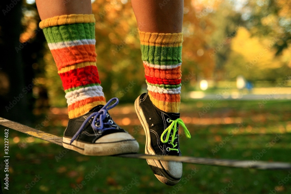 Walking the slackline in sneakers and colour socks Stock Photo | Adobe ...