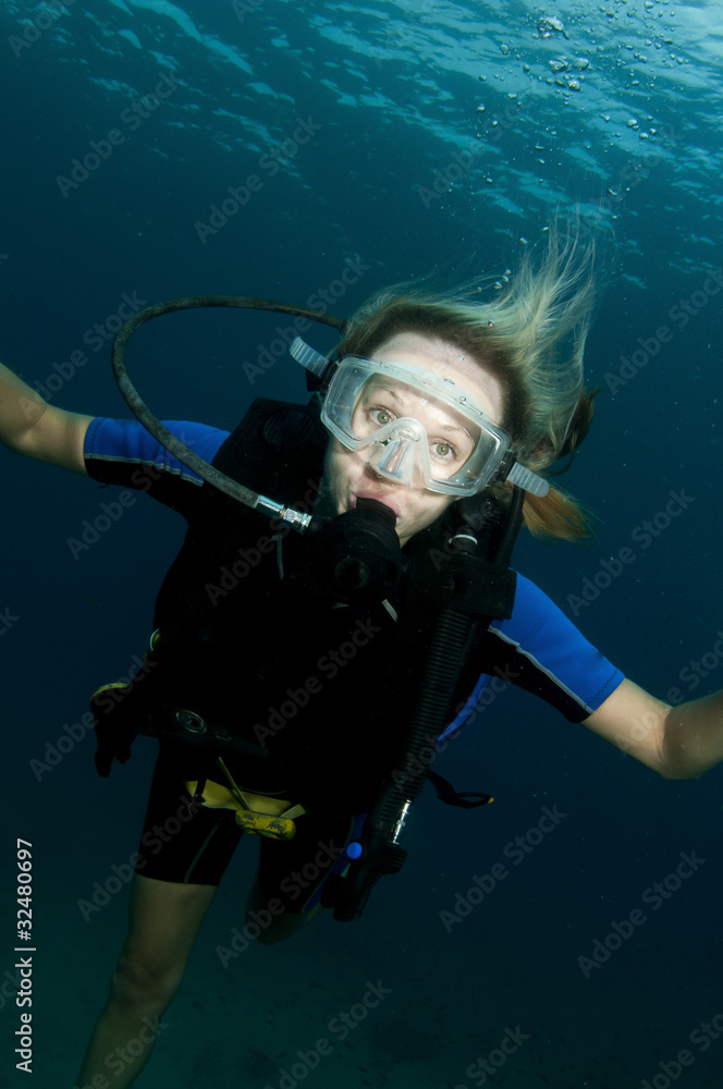 sexy blonde female scuba diver swims in clear blue water Stock Photo ...