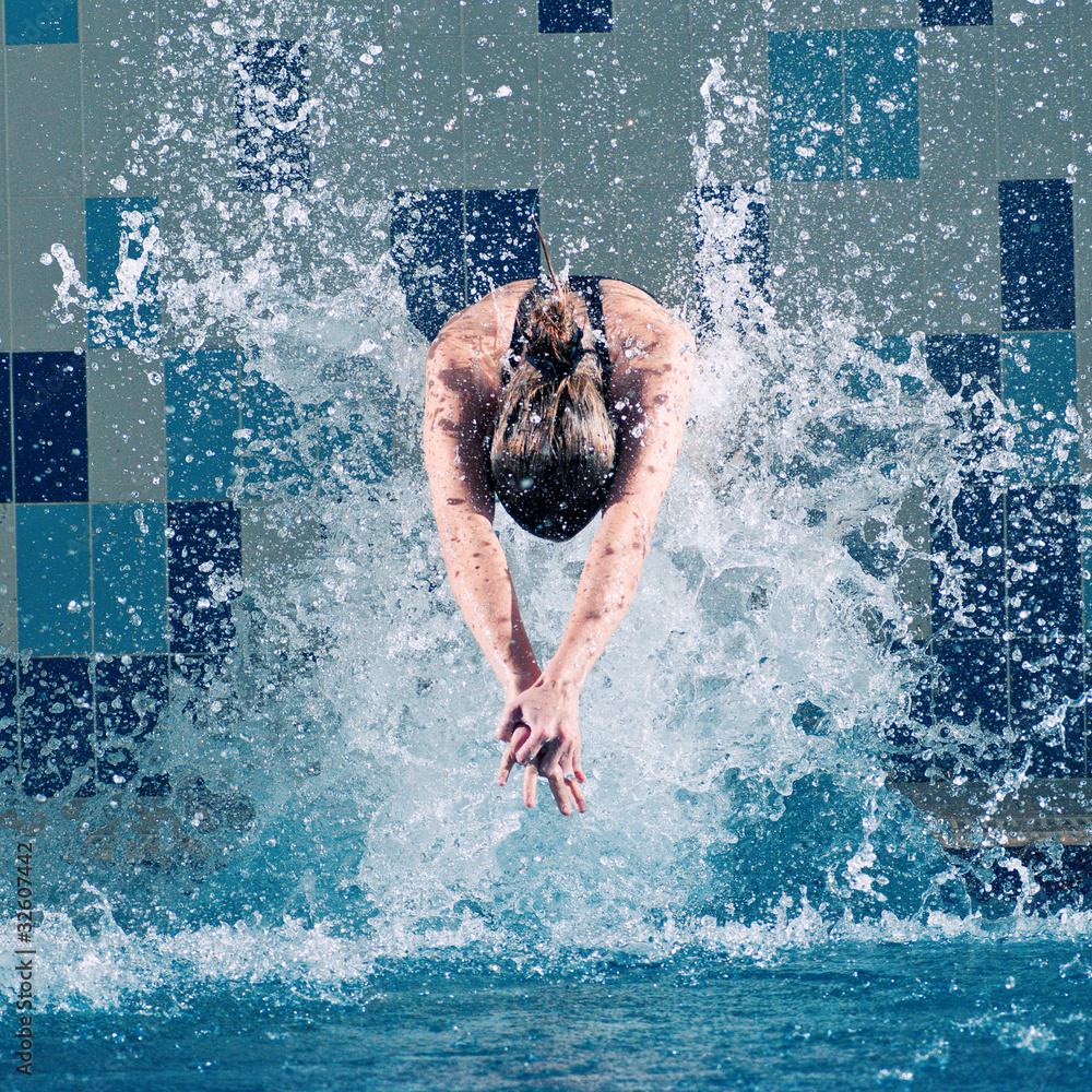 Swimmer jumping in swimming pool Stock Photo | Adobe Stock