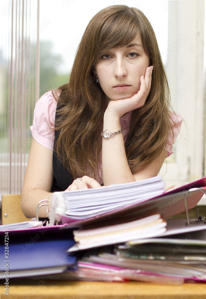 Boring girl works with documents at the office Stock Photo | Adobe Stock
