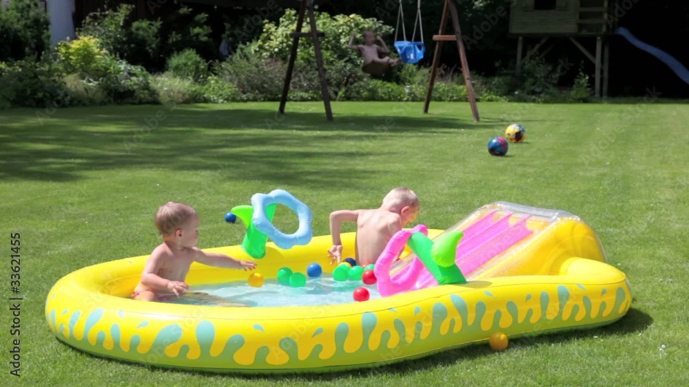 Children splashing water in swimming pool Stock Video | Adobe Stock