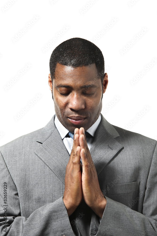 Studio portrait of praying young black man Stock Photo | Adobe Stock