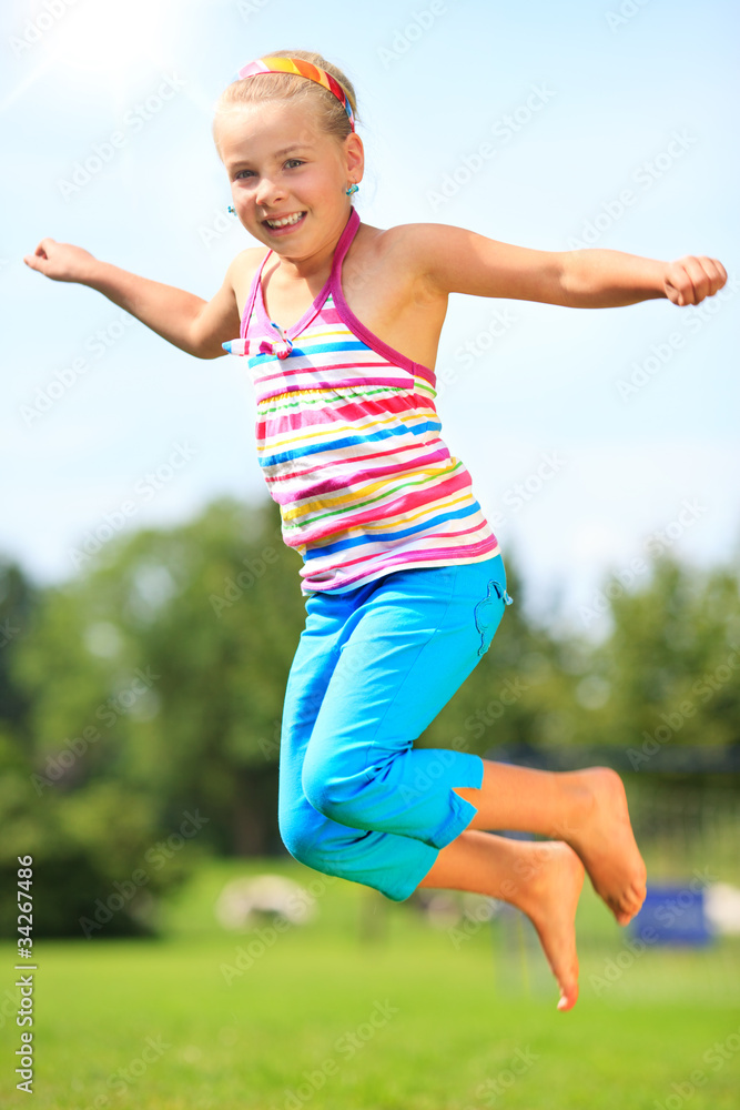 little girl jumping outdoor smiling Stock Photo | Adobe Stock