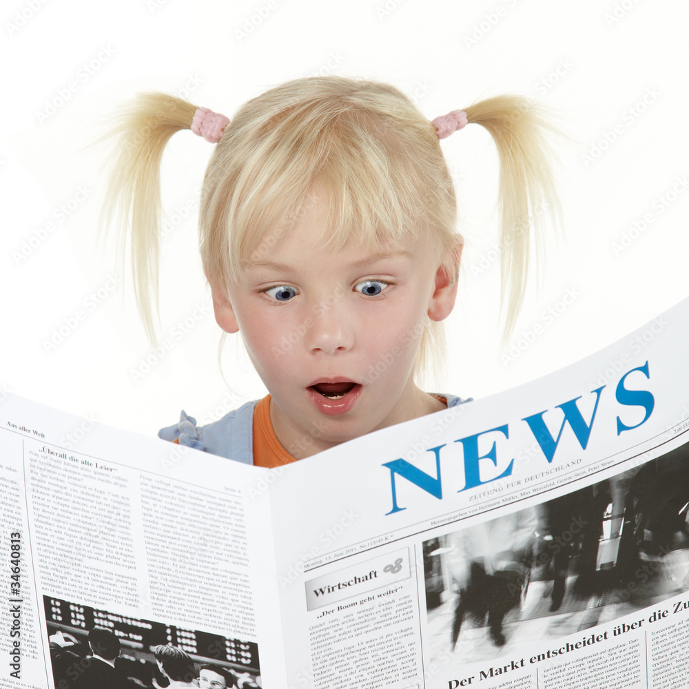 Cute blond girl reading newspaper is very surprised Stock Photo | Adobe ...