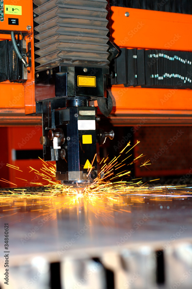 Industrial laser with sparks flying around Stock Photo | Adobe Stock