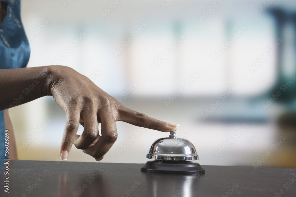 Black woman ringing reception desk bell Stock Photo | Adobe Stock