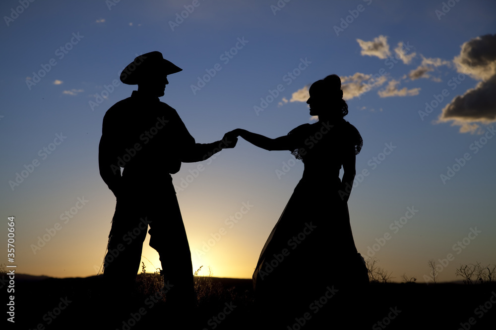 Cowboy couple silhouette holding hands Stock Photo | Adobe Stock
