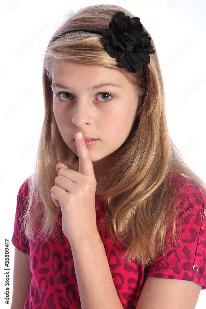 Frightened school girl child makes keep quiet sign Stock Photo | Adobe ...