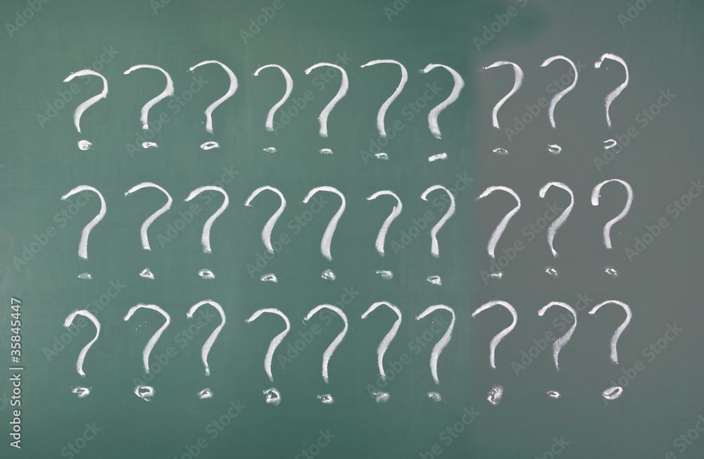 Drawing question marks on blackboard. Stock Photo | Adobe Stock