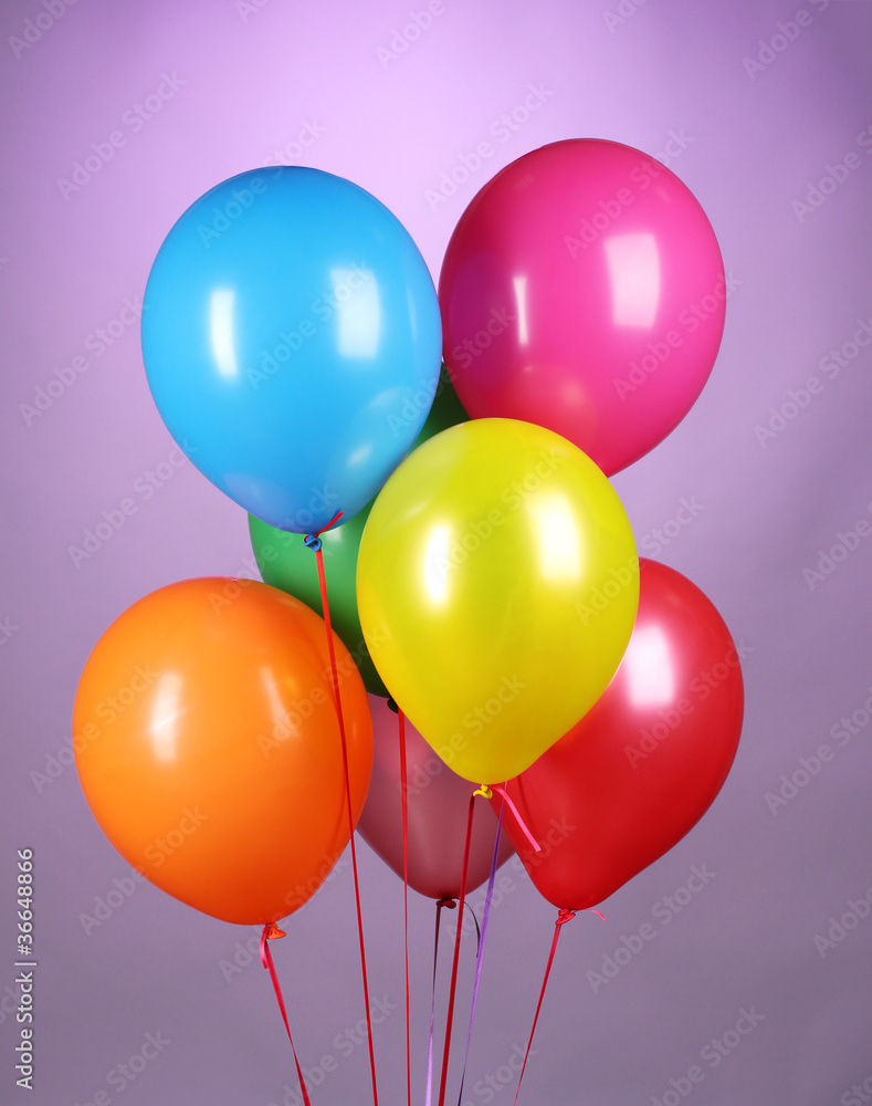 bright balloons on purole background Stock Photo | Adobe Stock