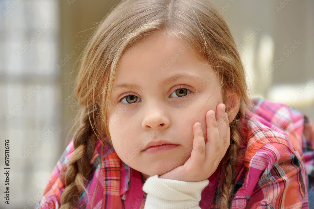 Little Girl Resting With Hand Under Chin Stock Photo | Adobe Stock