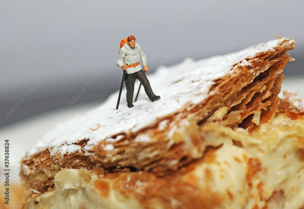 Small hiker figure walk on cake with castor sugar imitating snow Stock ...