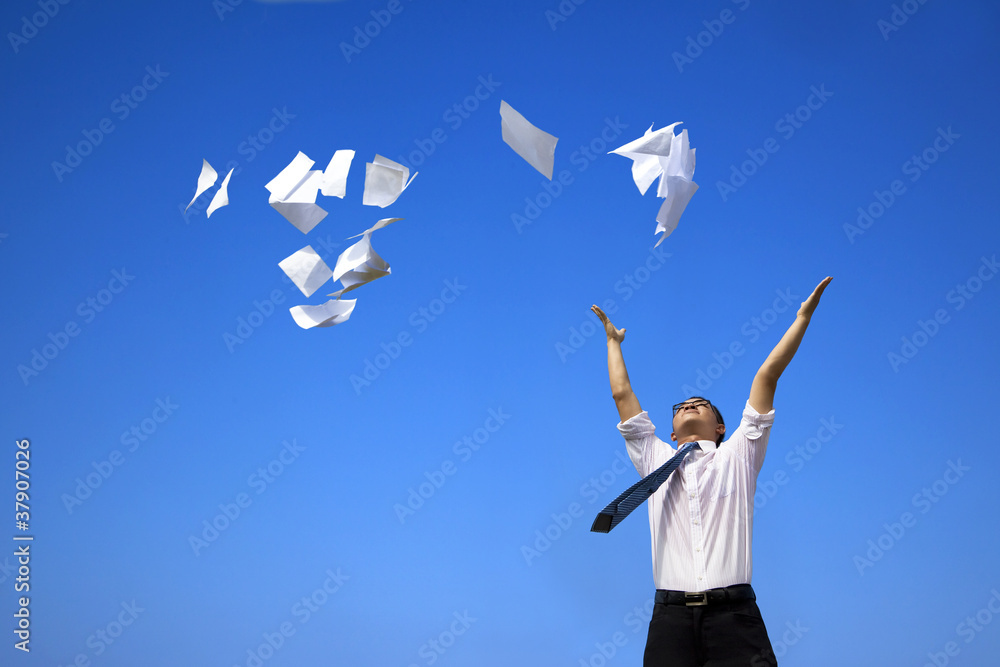 business man relaxing and throwing white papers to the blue sky Stock ...