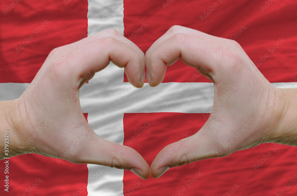 Heart and love gesture showed by hands over flag of denmark back Stock ...