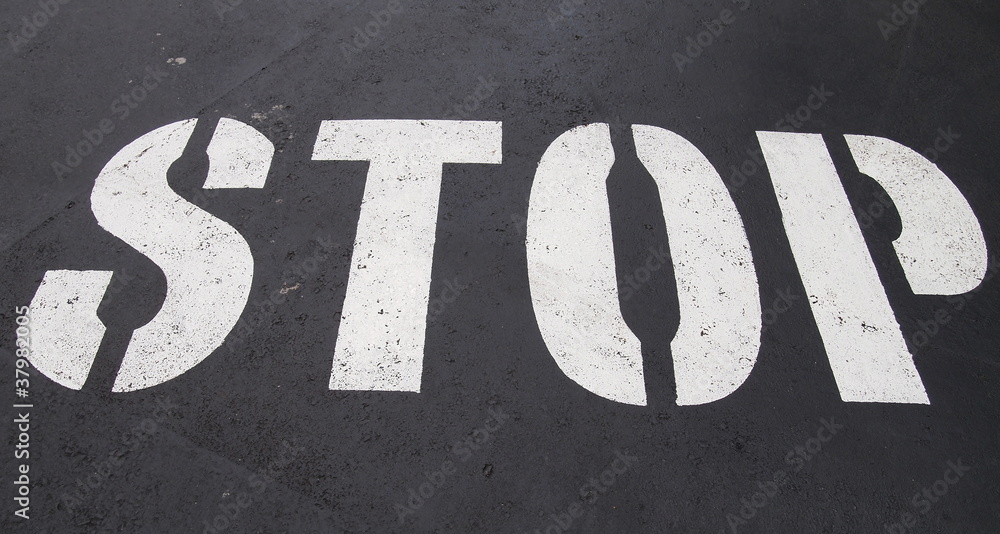 stop sign painted on a asphalt road surface Stock Photo | Adobe Stock