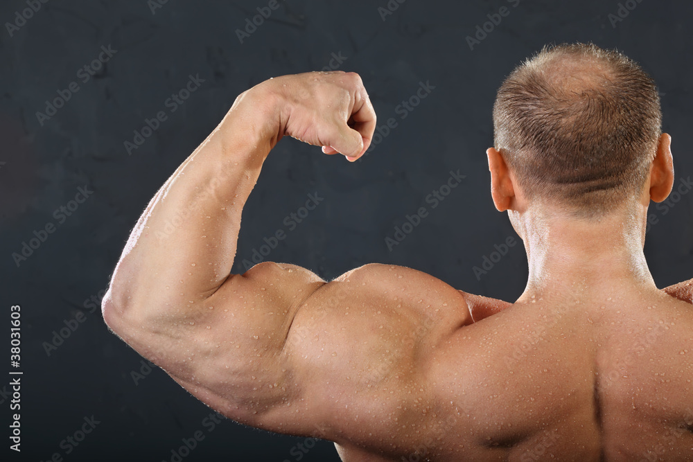 Back, neck and hand muscles of undressed tanned wet bodybuilder Stock ...