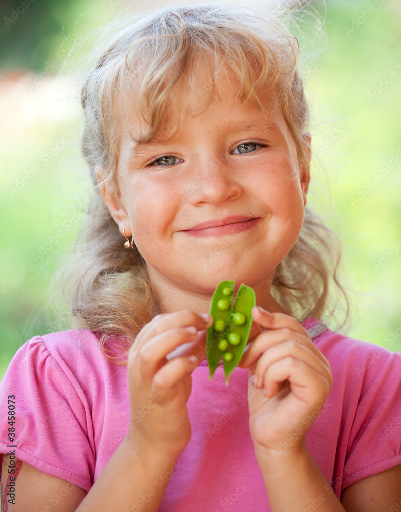 Girl with peas Stock Photo | Adobe Stock