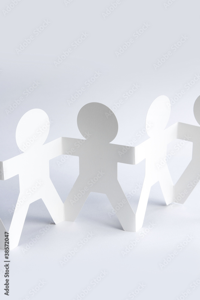 Paper doll team holding hands together united. Teamwork concept Stock ...