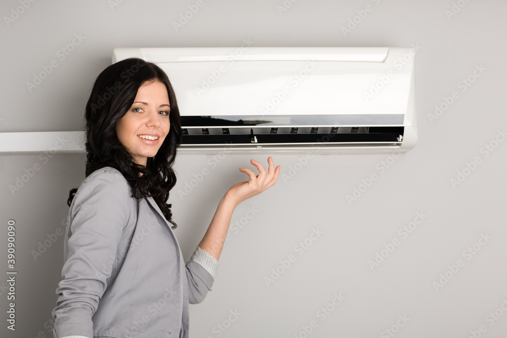 girl showing the air conditioner Stock Photo | Adobe Stock