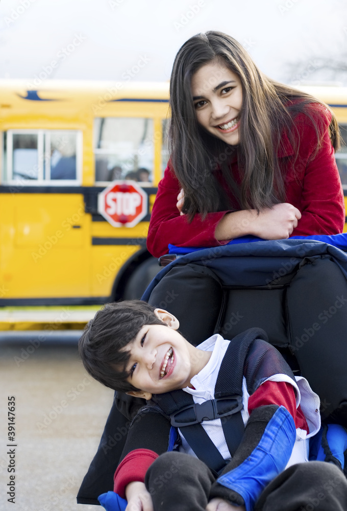 Big sister with disabled brother in wheelchair by school bus Stock ...