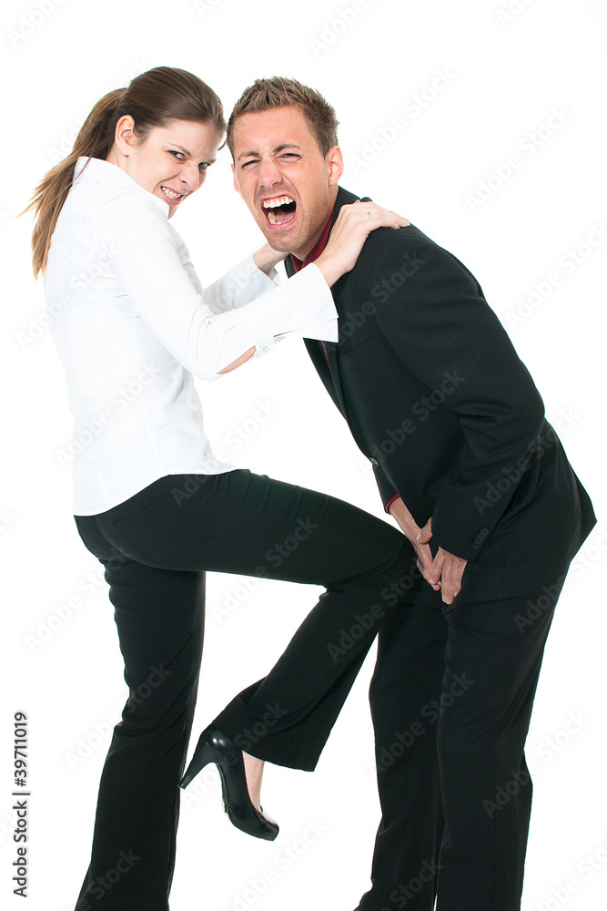 Beautiful woman kicking a businessman Stock Photo | Adobe Stock