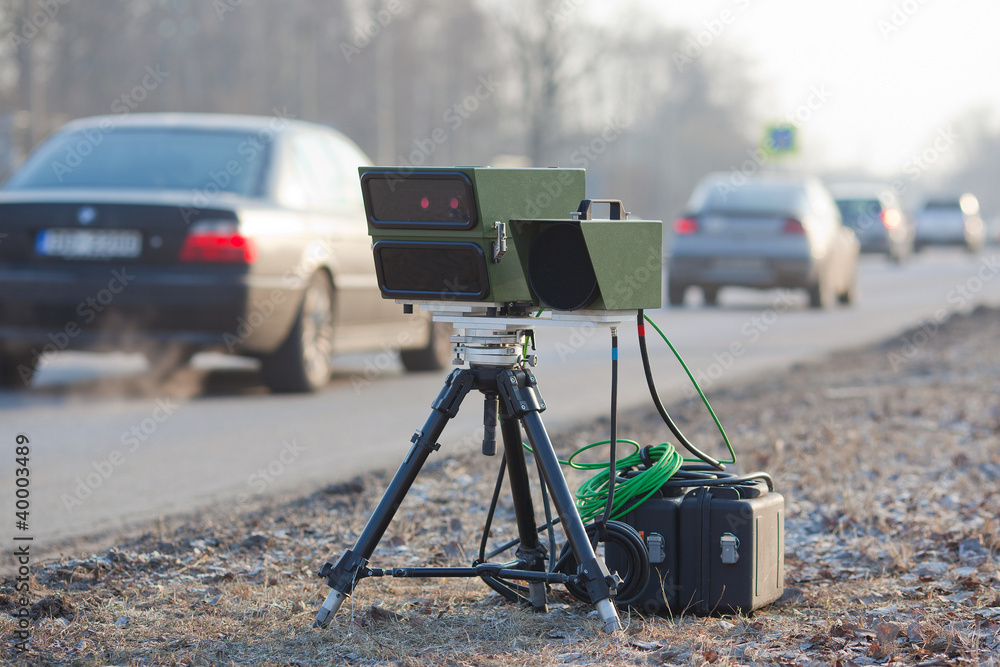 speed camera at the side of the road with blurred car passing Stock ...