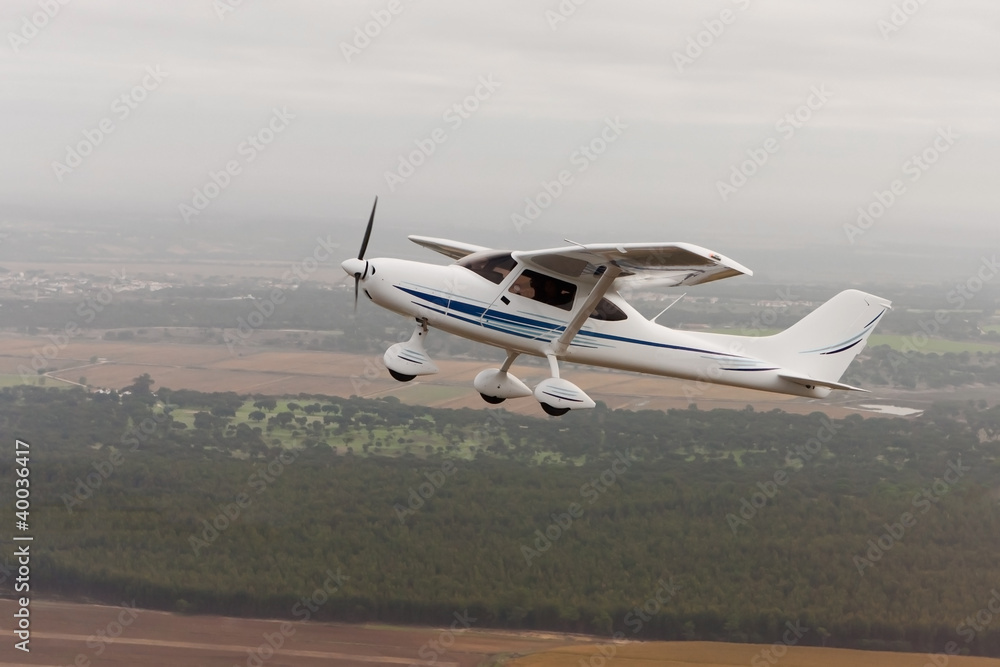 Small airplane flying Stock Photo | Adobe Stock