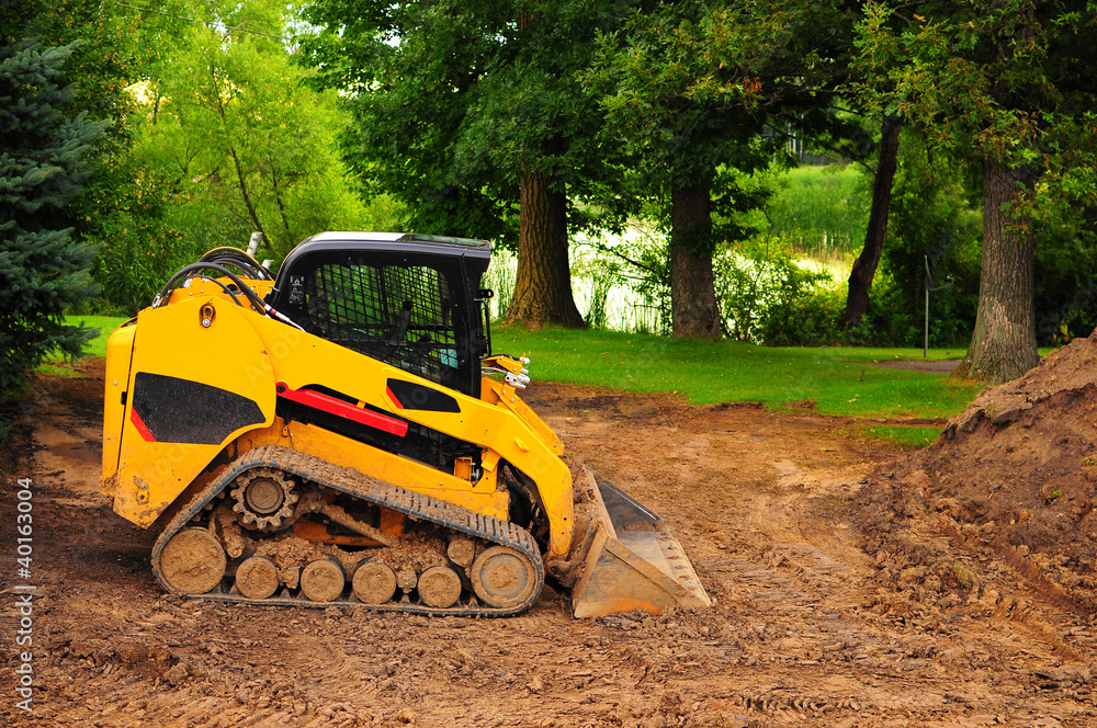 yellow bulldozer, tractor fitted with a dozer blade, on soil land in ...
