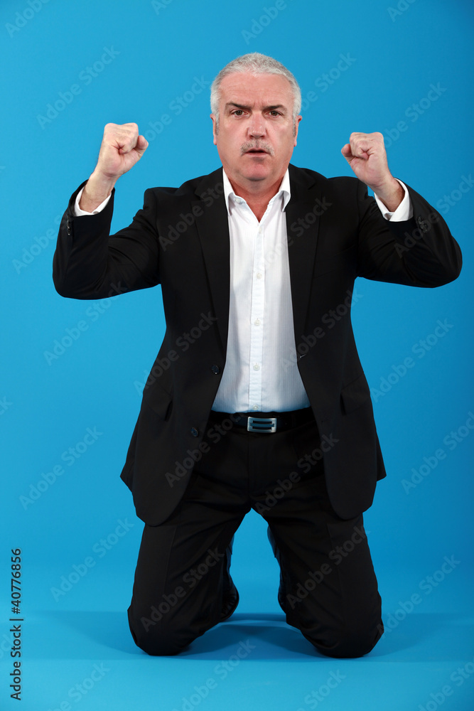 Angry man on his knees Stock Photo | Adobe Stock