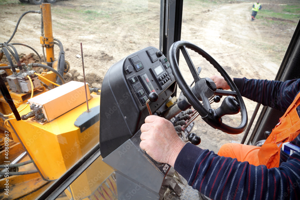 Driver in grader at construction site Stock Photo | Adobe Stock